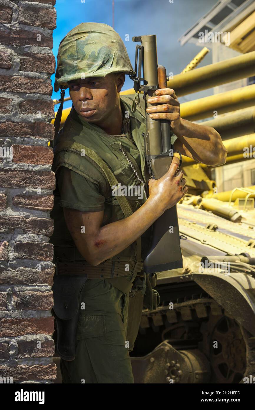 A soldier on guard in front of a Rifle Multiple 106mm Self-propelled ...