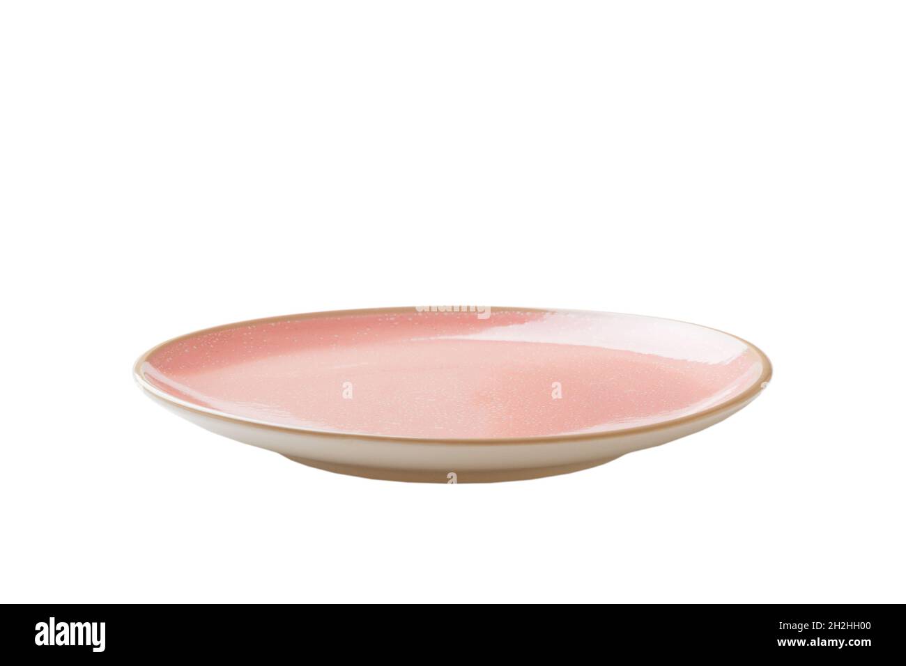 Pink ceramic round plate isolated over white background. perspective ...