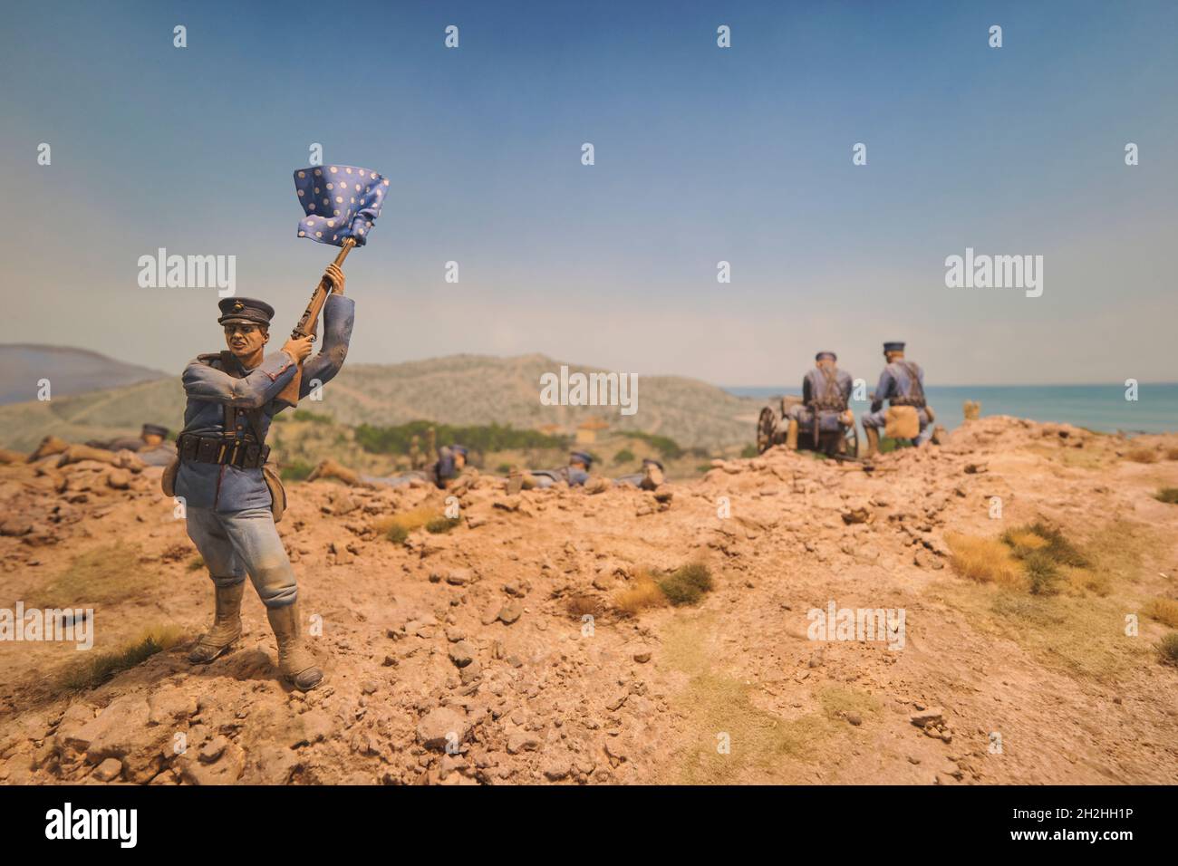 Sargeant John Quick uses a flag to signal a Navy gunship during the ...
