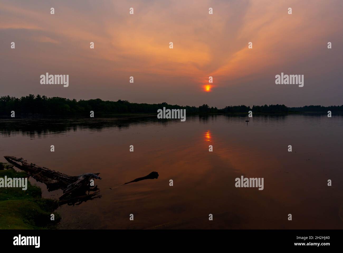 Beautiful sunset on the river bank creating a beautiful natural light ...