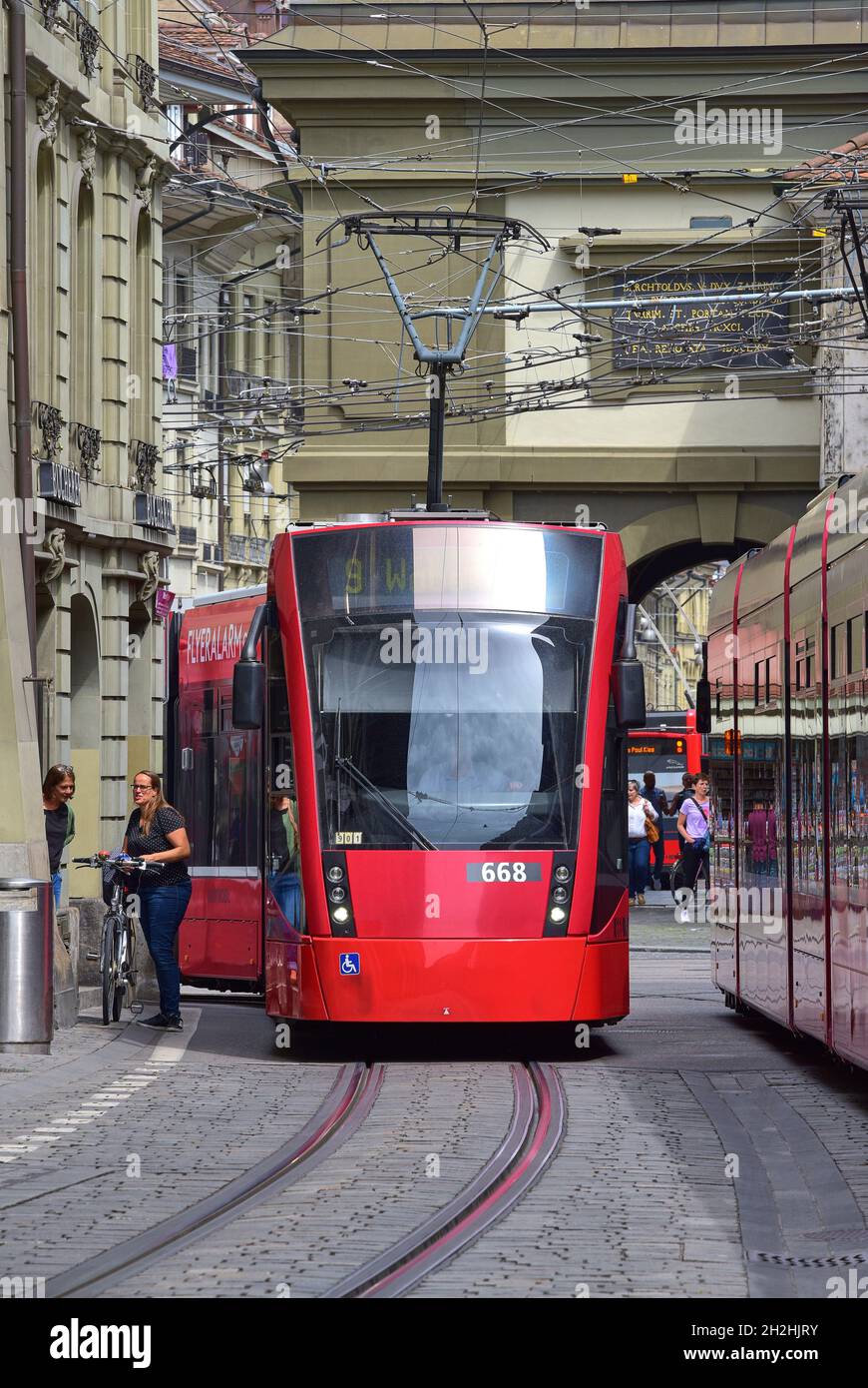 Traditional red trams at the streets of Bern, Switzerland Stock Photo ...