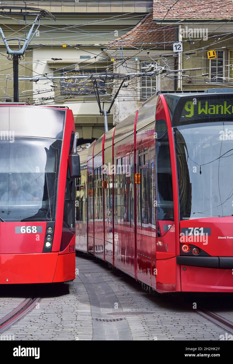 Traditional red trams at the streets of Bern, Switzerland Stock Photo ...