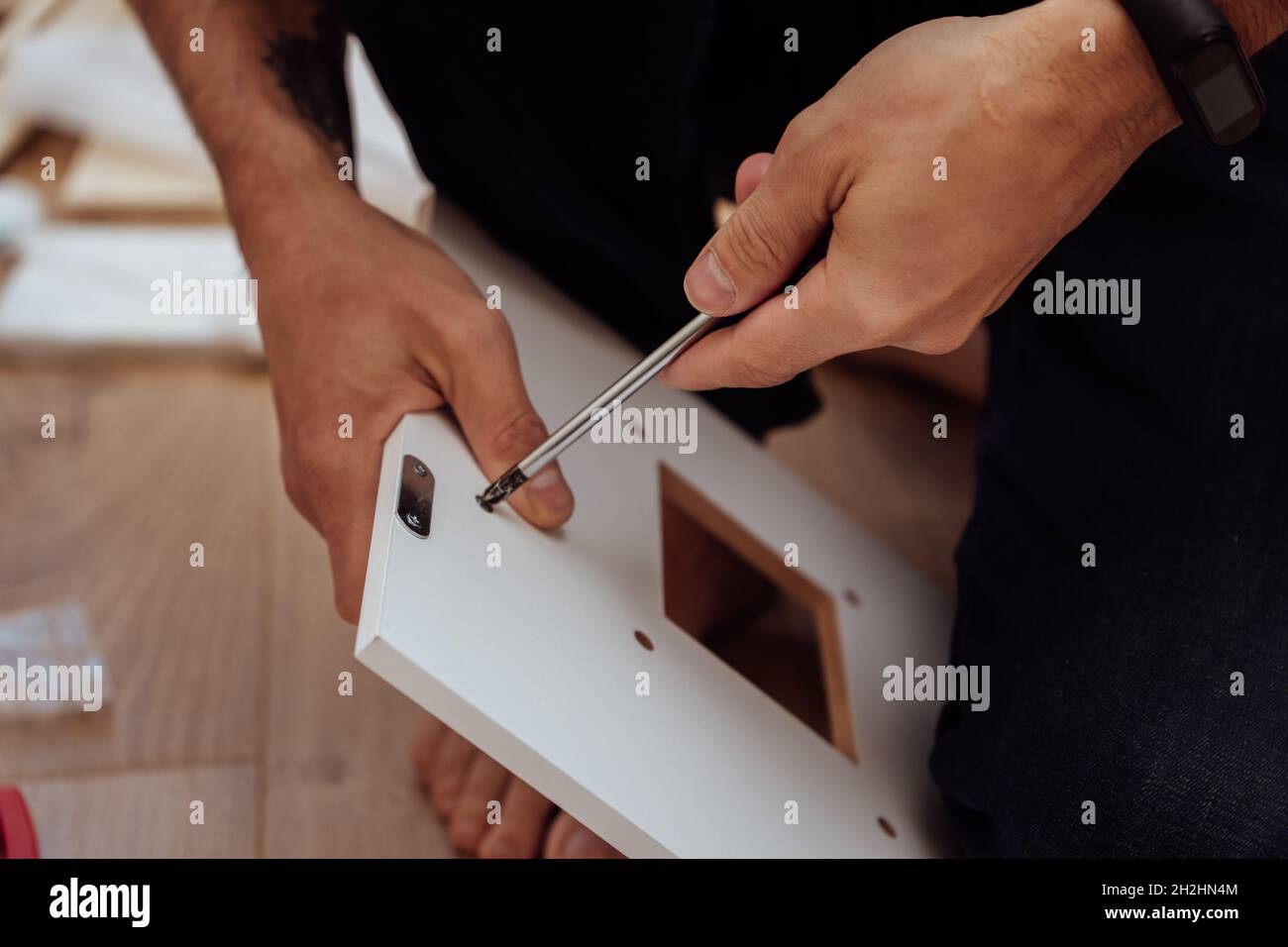 Man fixing home furniture with screwdriver Stock Photo - Alamy