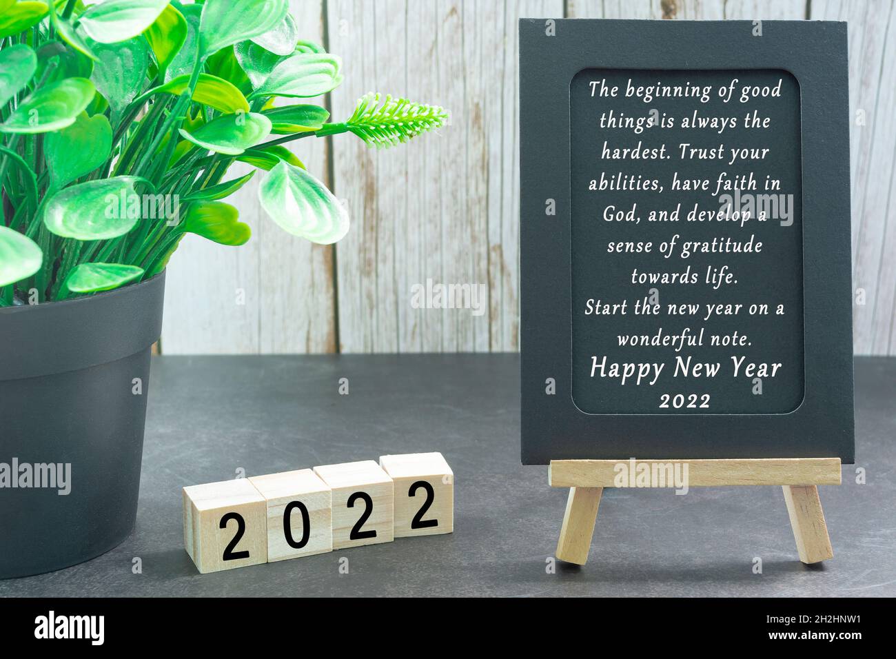 Motivational and inspirational quote on black paper with potted plant ...