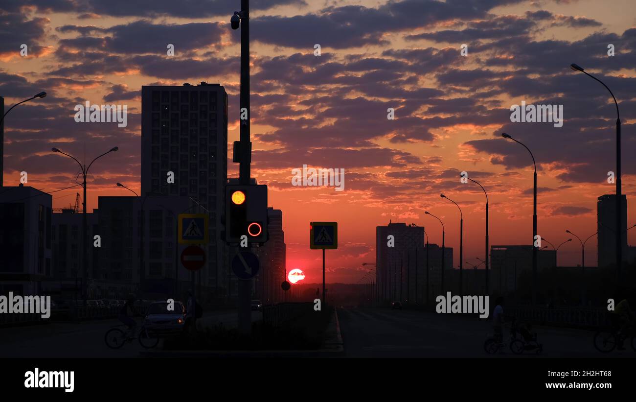 Early morning sunrise in a city street. Breathtaking pink and orange ...