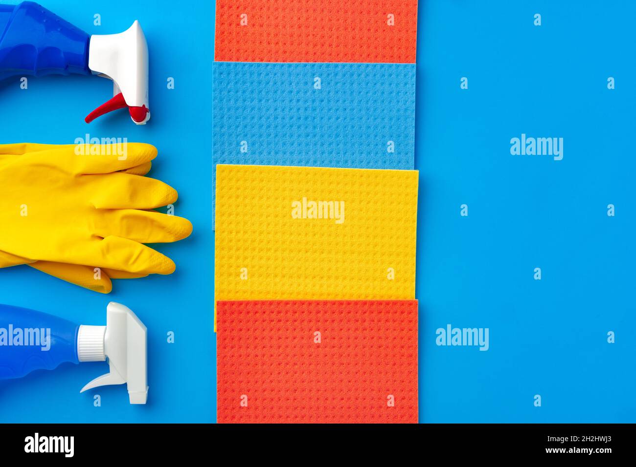 House cleaning supplies on blue color background Stock Photo - Alamy