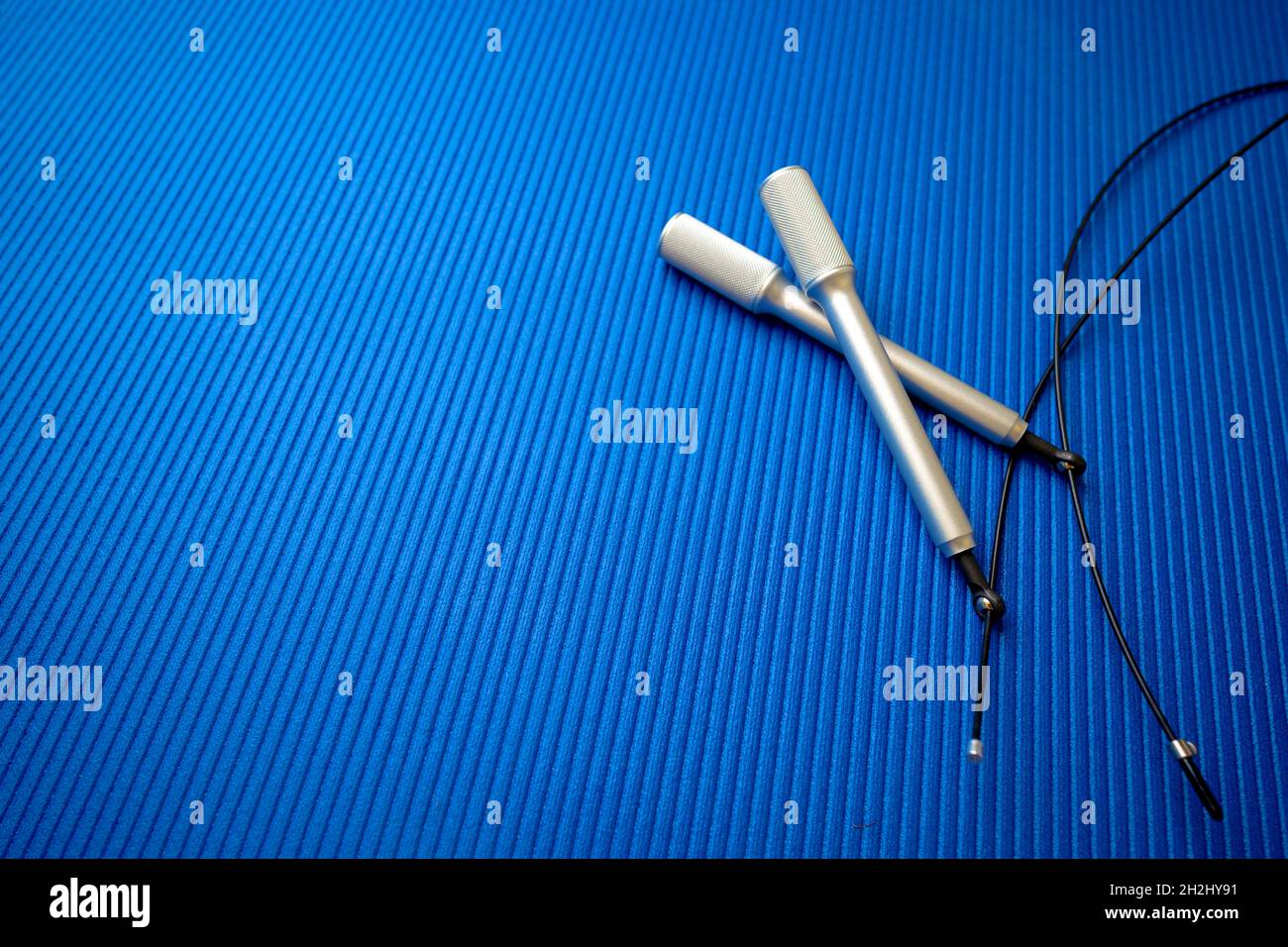 Jumping rope on blue mat background in a gym Stock Photo - Alamy