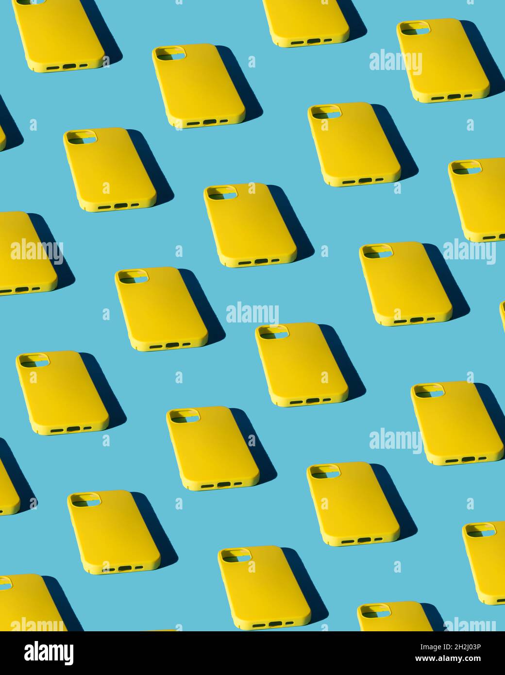 Mobile phone yellow cover pattern on blue background. Flat lay, top ...