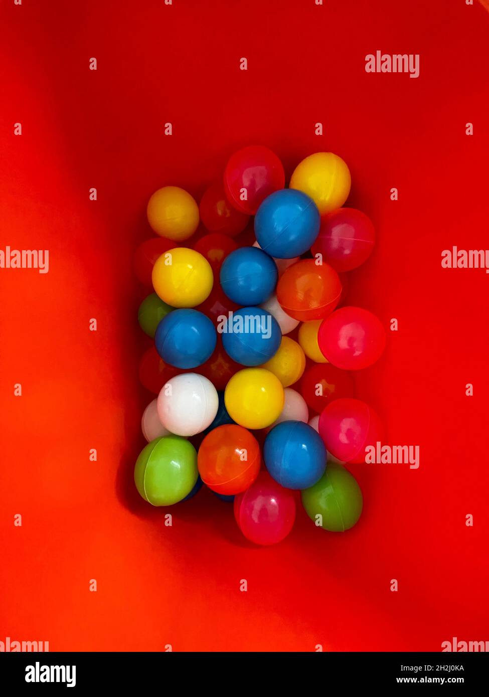 Colorful plastic toy balls in red container Stock Photo - Alamy