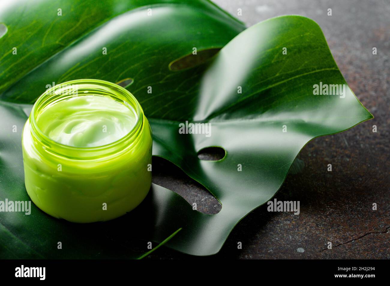 Cosmetic cream on green leaf top view Stock Photo - Alamy