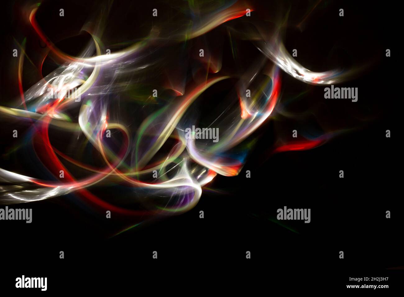 Colored lights forming abstract shapes and patterns on a black ...