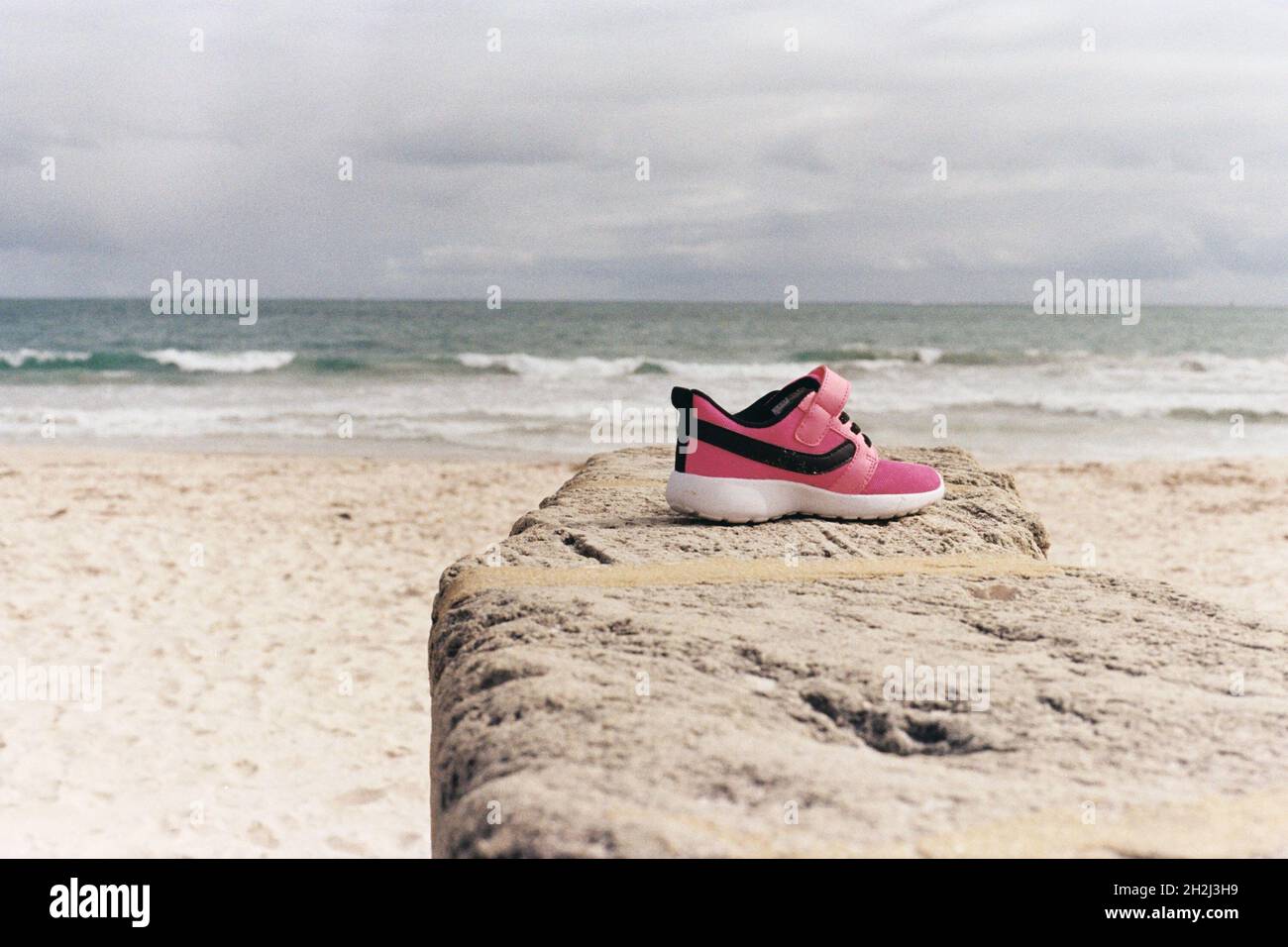 Shoe on the beach Stock Photo - Alamy
