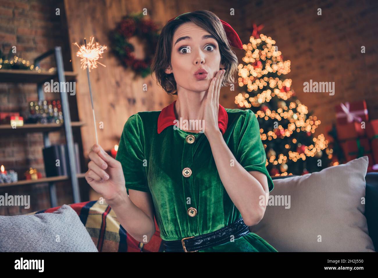 Photo of excited funny lady hand cheek open mouth hold bengal fire wear ...