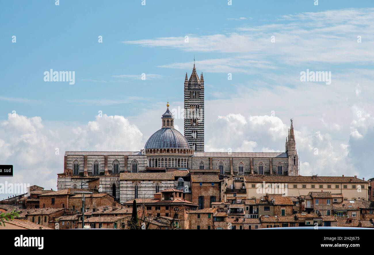 Siena's old town with red rooftops, and the ancient clocktower and ...