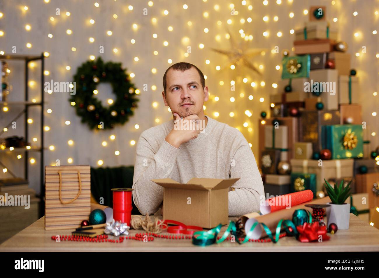 Man sitting thinking christmas hi-res stock photography and images - Alamy