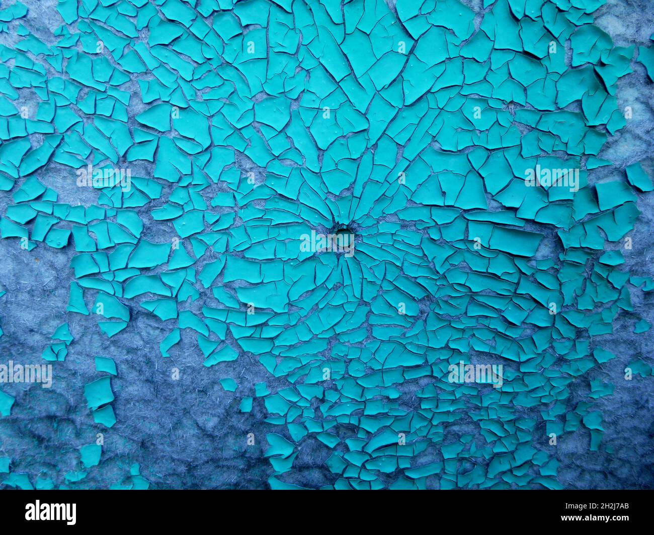 Blue peeling paint on the wall. Weathered rough painted surface with ...
