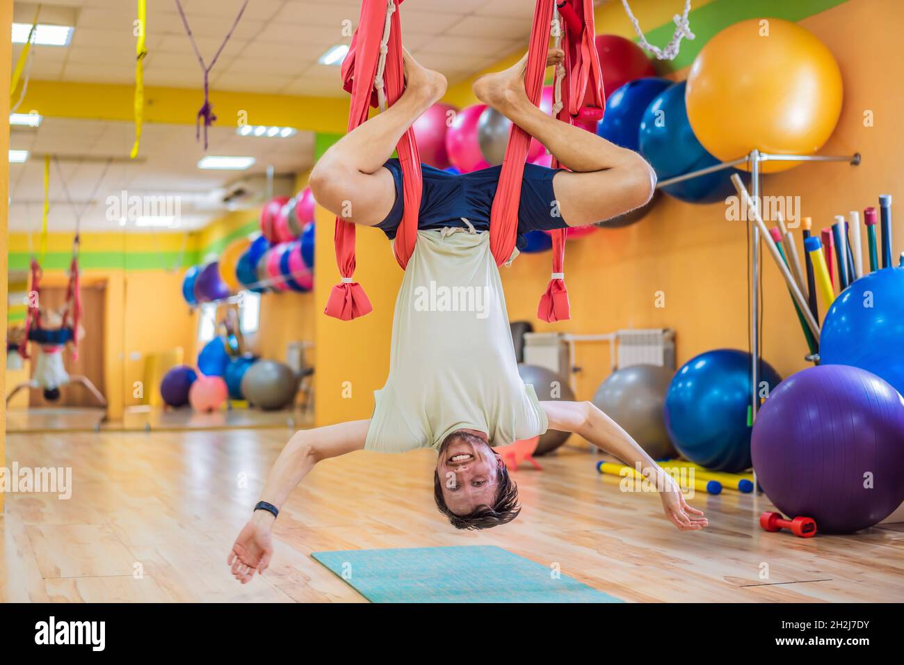 Young man practicing aerial yoga in gym. Lifestyle Stock Photo - Alamy