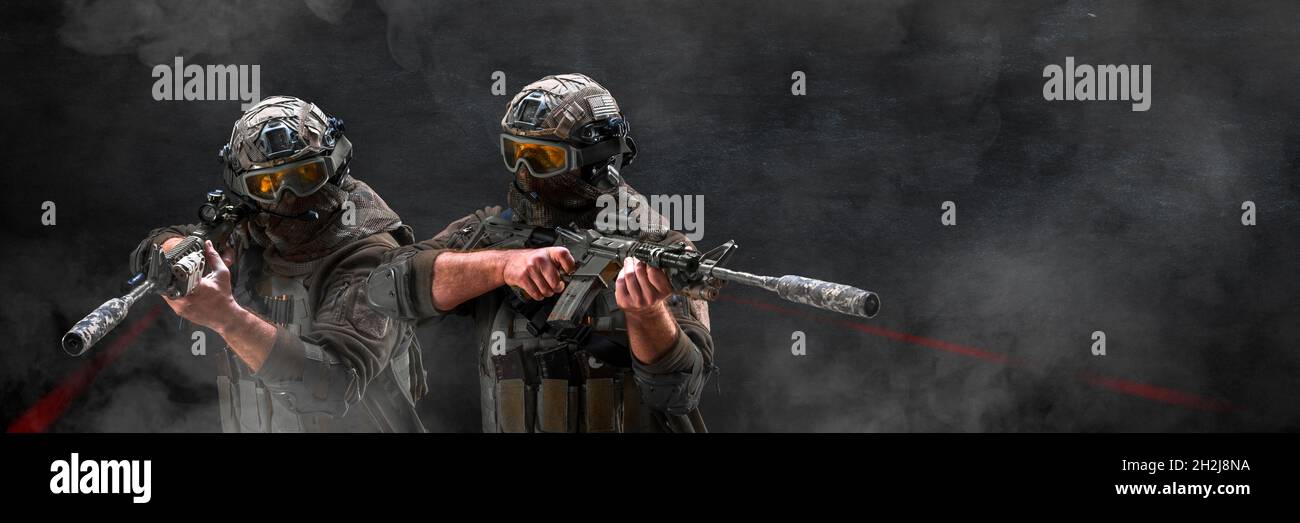 Two mercenary soldiers during a special operation in the smoke against ...