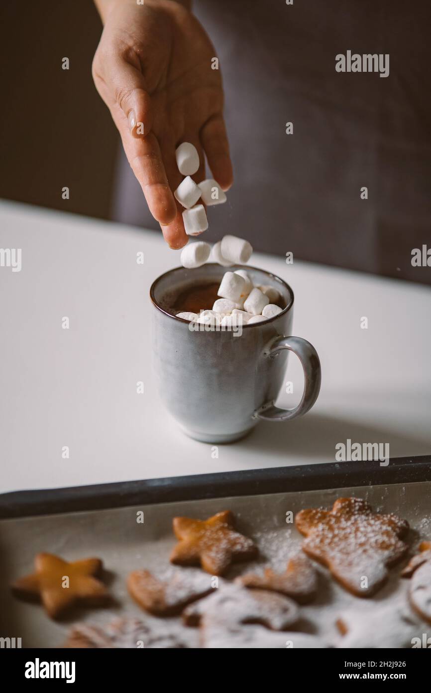Woman puts marshmallows in mug hi-res stock photography and images - Alamy