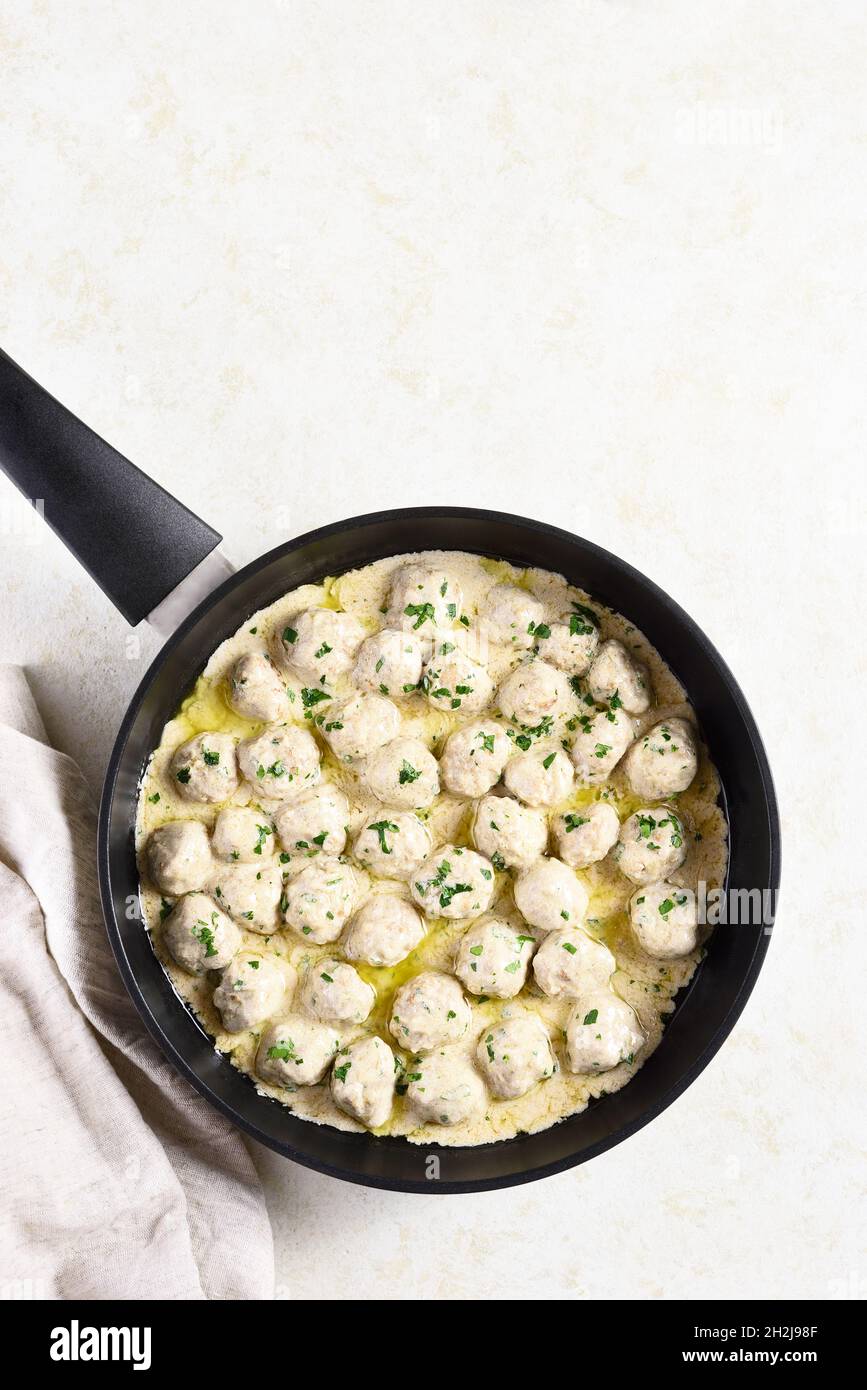 Delicious homemade swedish meatballs with creamy white sauce in frying ...