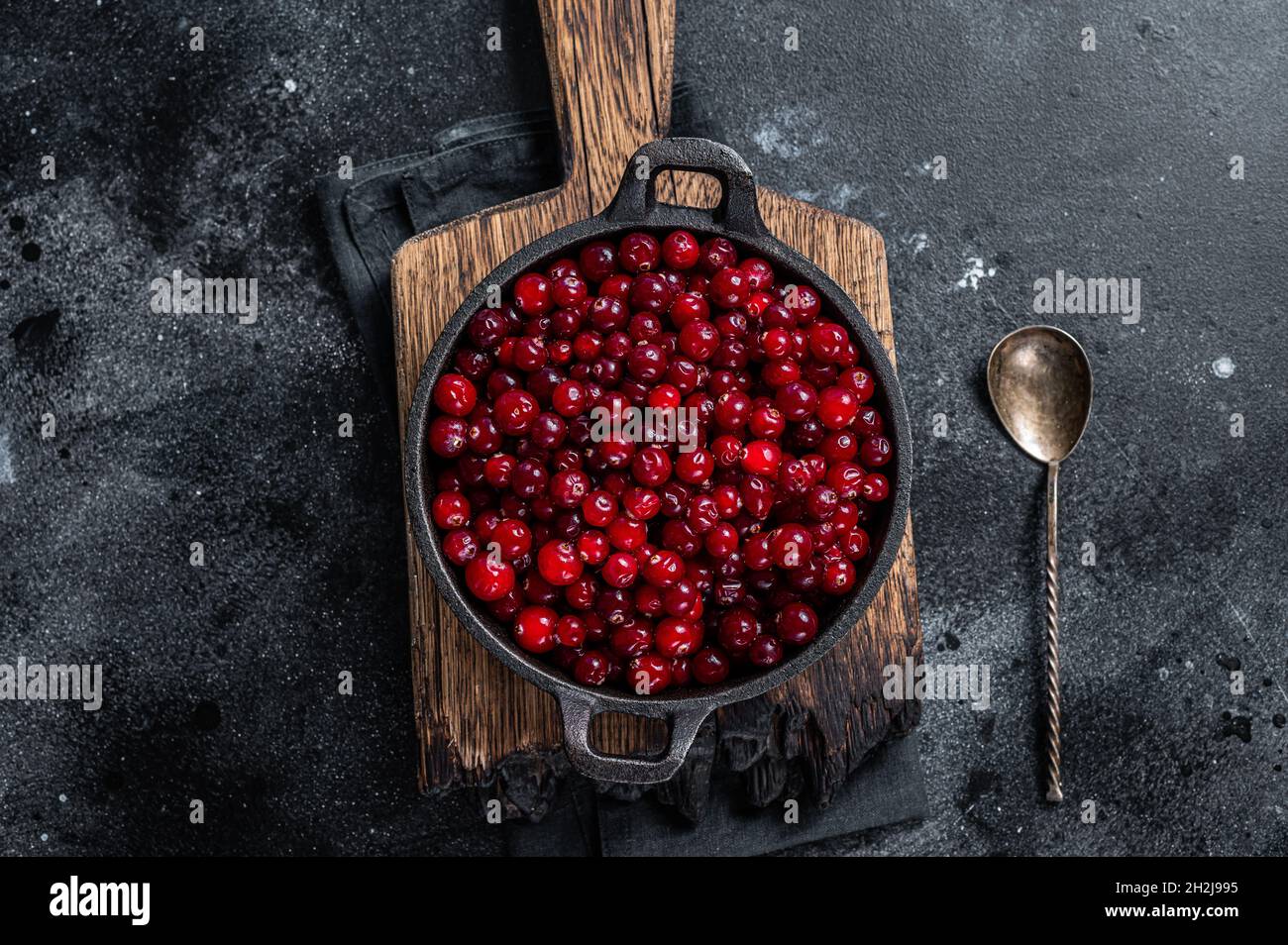 Red fresh Cranberry berry in a pan. Black background. Top view Stock ...