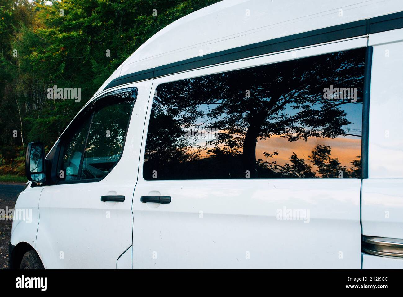 view of the sunrise over loch ness reflected in the window of a ...