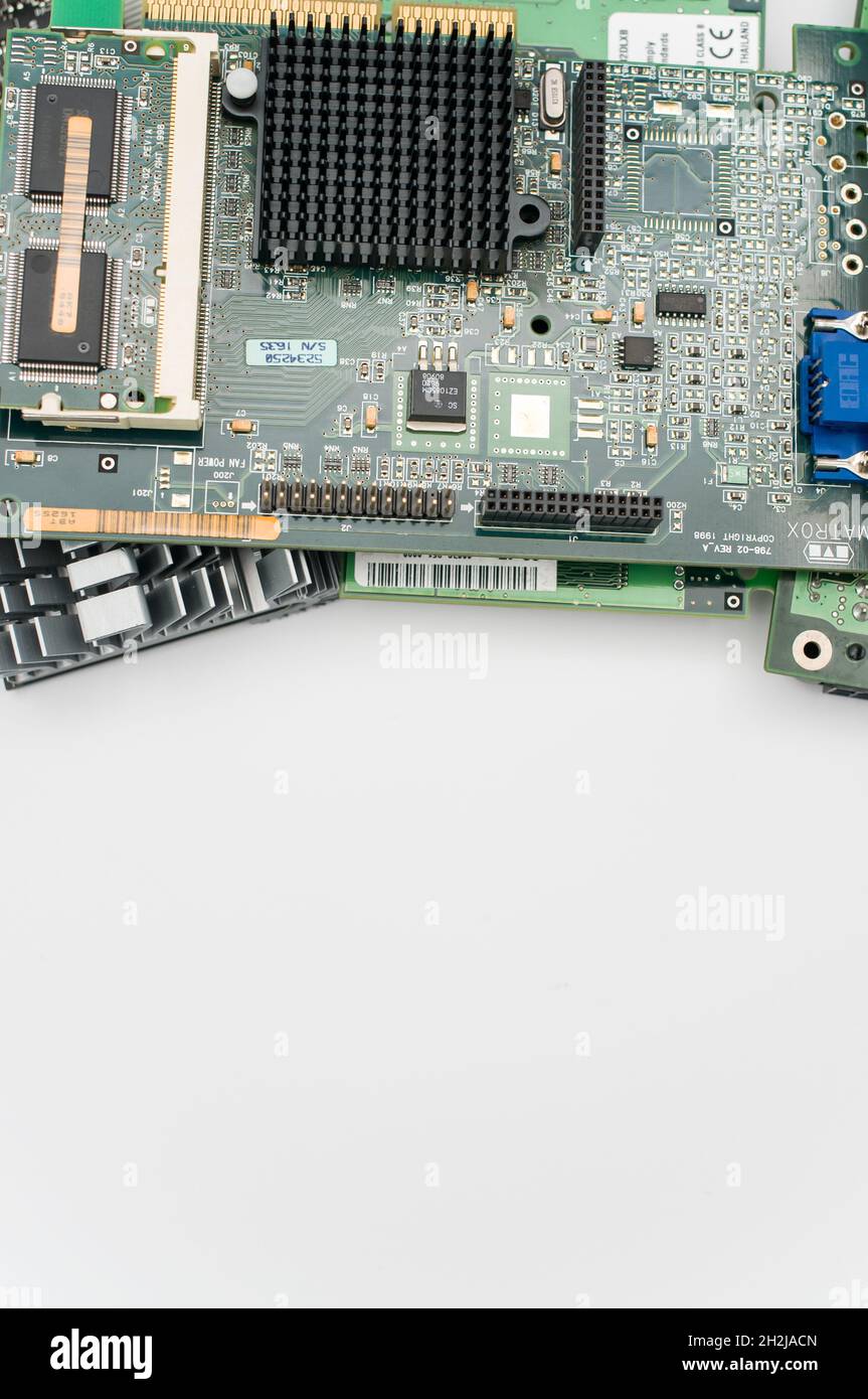 electronic devices integrated circuit boards piled up on a white ...