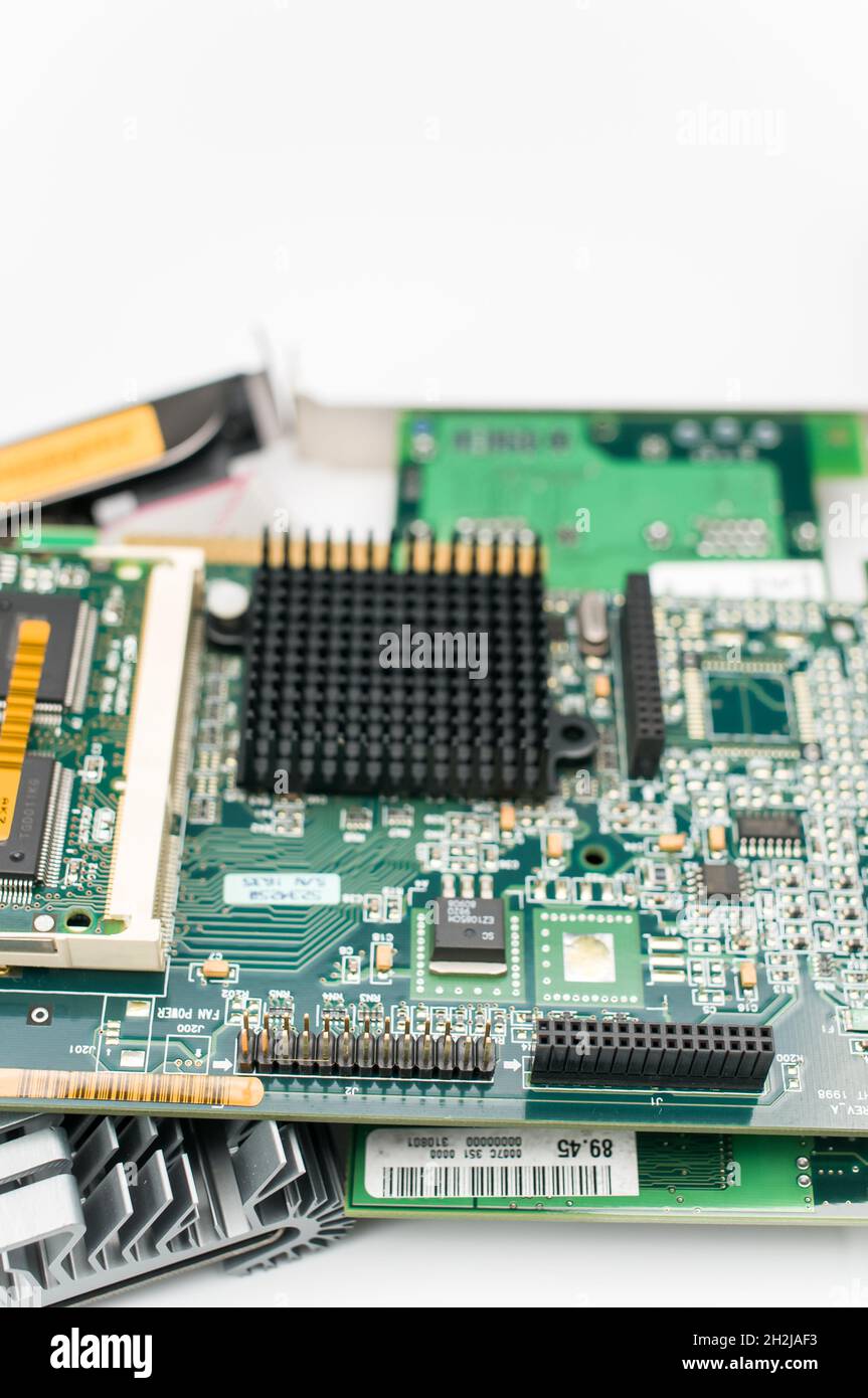 electronic devices integrated circuit boards piled up on a white ...