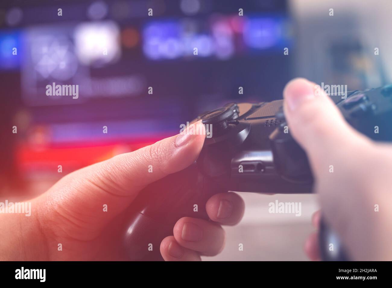 Playing video games on a console with wireless controller at home ...