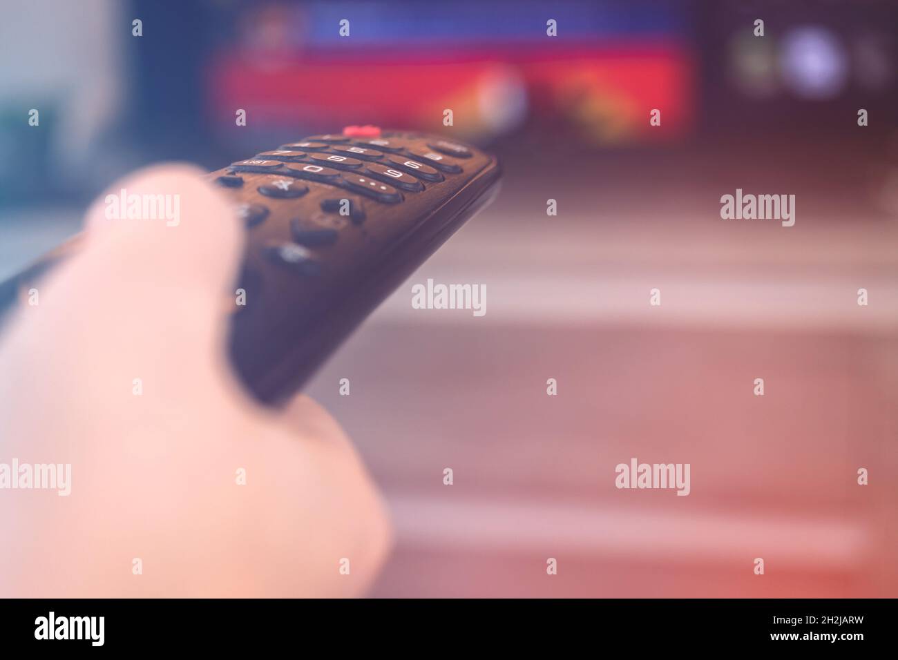 Smart TV remote control in hand. Controller for TV switches channels ...