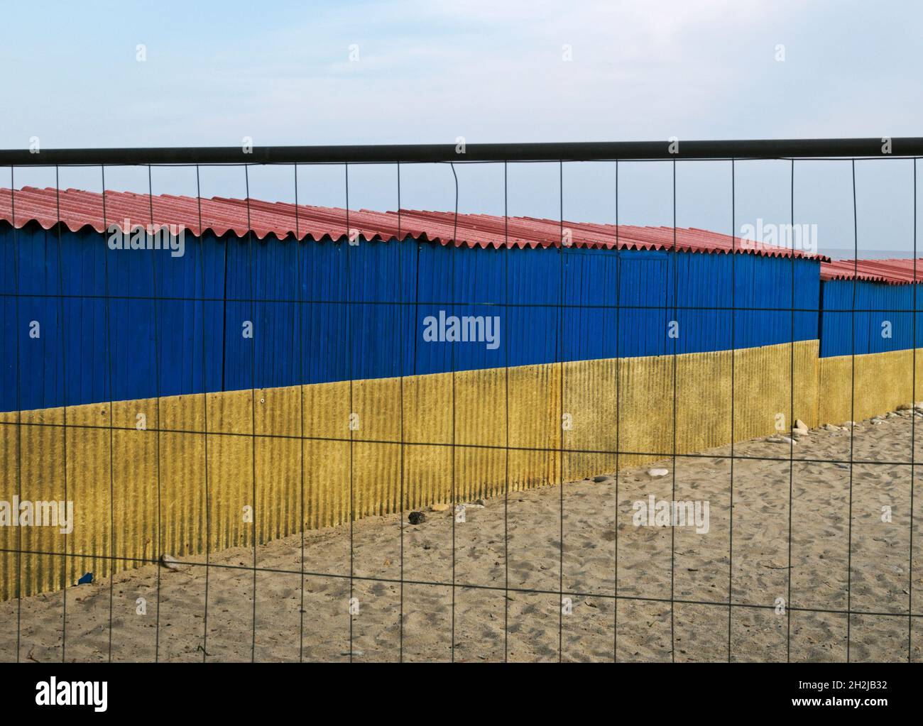 beach huts behind a fence Stock Photo - Alamy