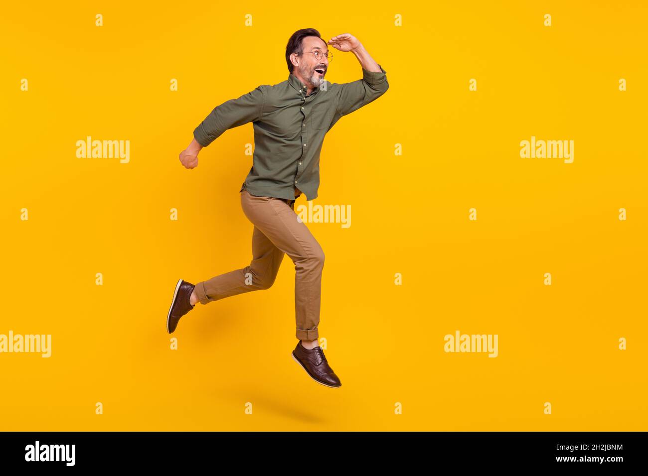 Full length body size view of attractive amazed man jumping running ...