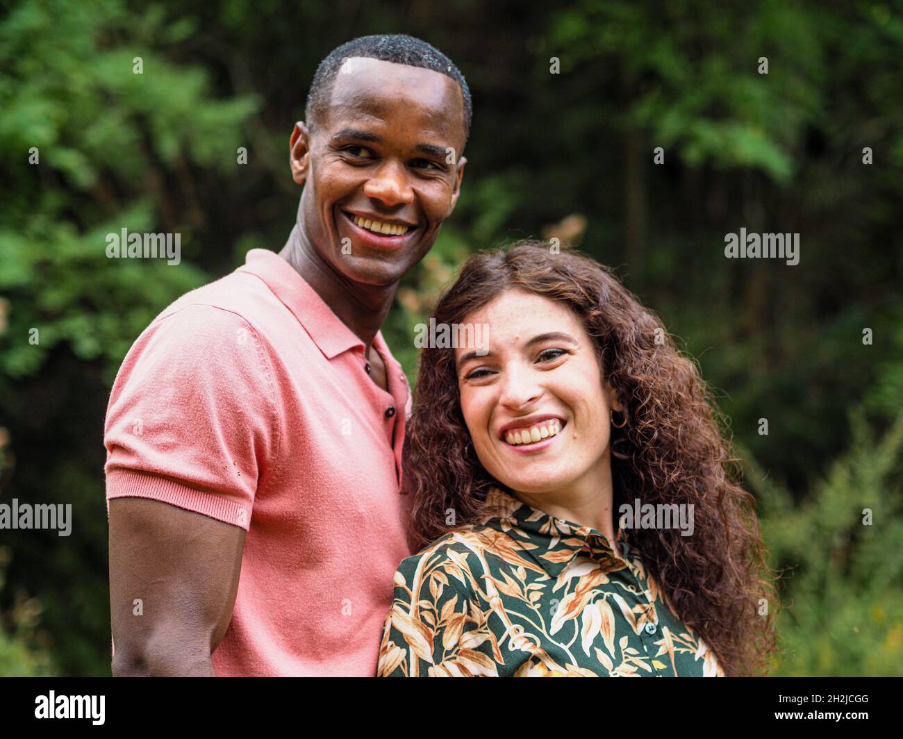 Happy mixed race couple in a forest Stock Photo - Alamy