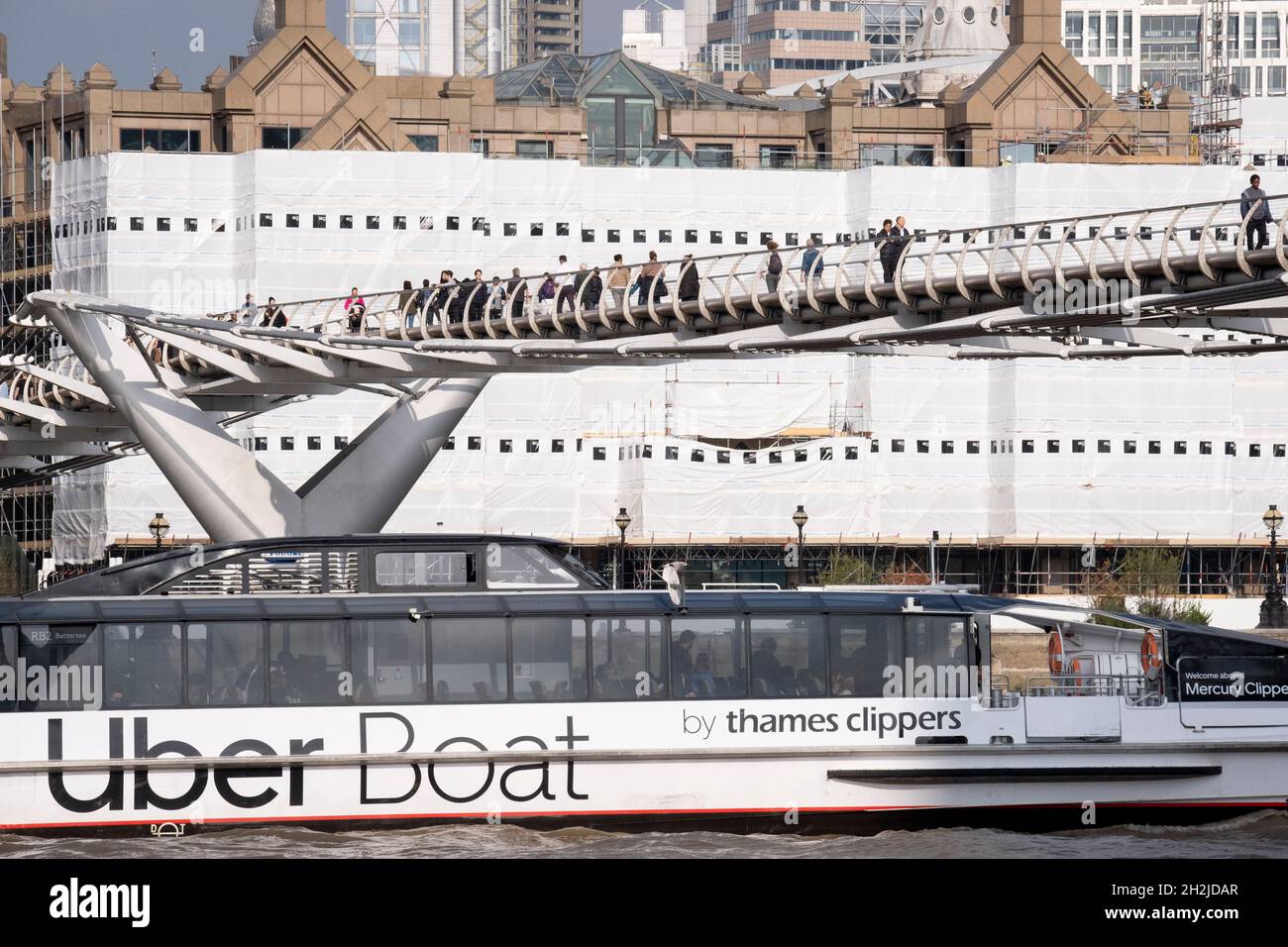 Uber Boat's 'Meteor Clipper' passes beneath the Millennium Bridge and ...