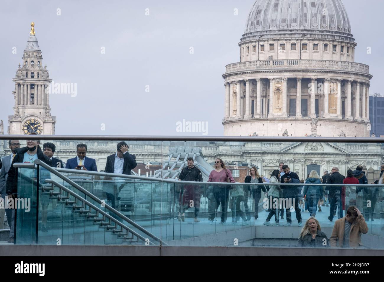 With the dome of St Paul's cathedral in the distance, a woman in a ...