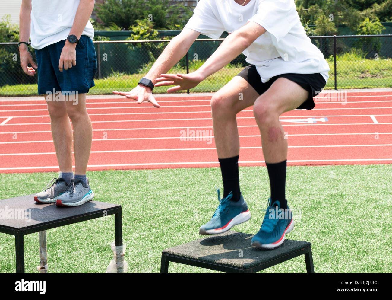 Athletes at a summer sports camp jumping onto different size plyo boxes ...