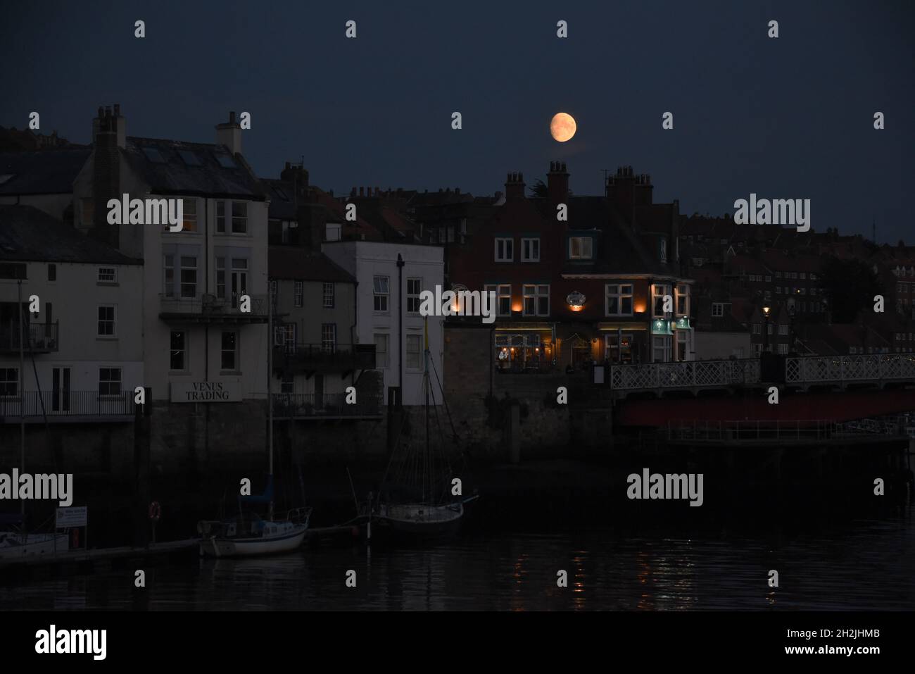 The moon rises over Whitby harbour Stock Photo - Alamy