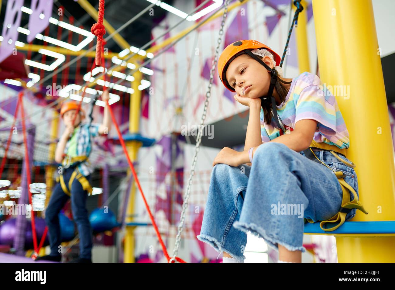 Tired girl in climbing area Stock Photo - Alamy