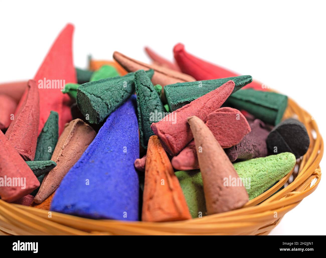 Colorful incense cones in a basket against a white background Stock ...