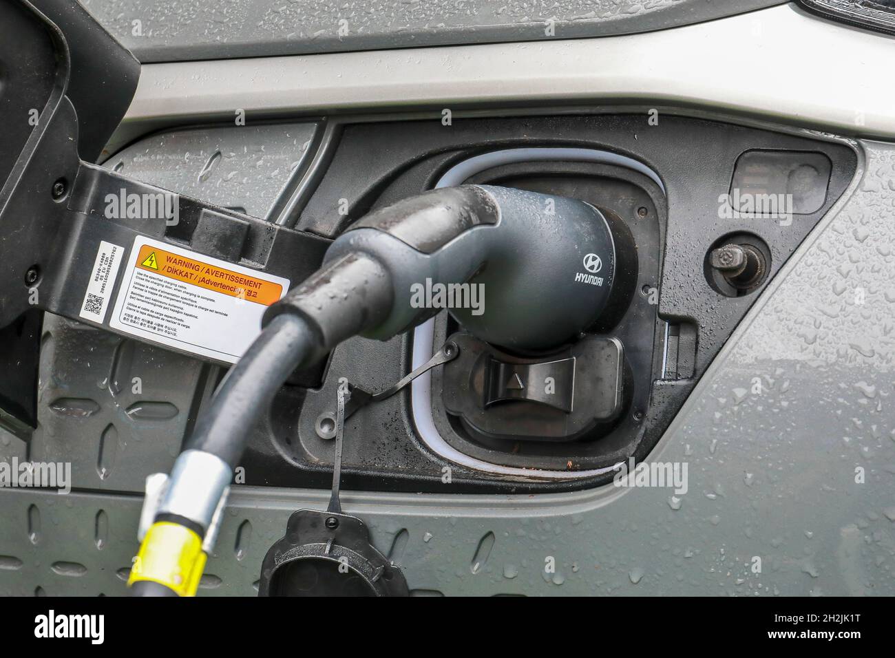 Hyundai Electric car plugged in to charging cable Stock Photo - Alamy