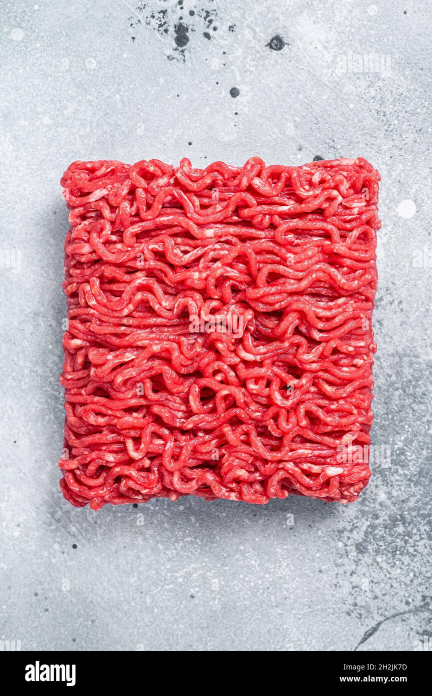 Raw Mince Ground meat on a butcher table. Gray background. Top view ...