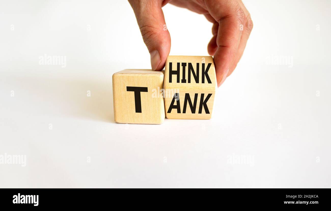 Think tank symbol. Businessman turns a wooden cube and changes the word ...