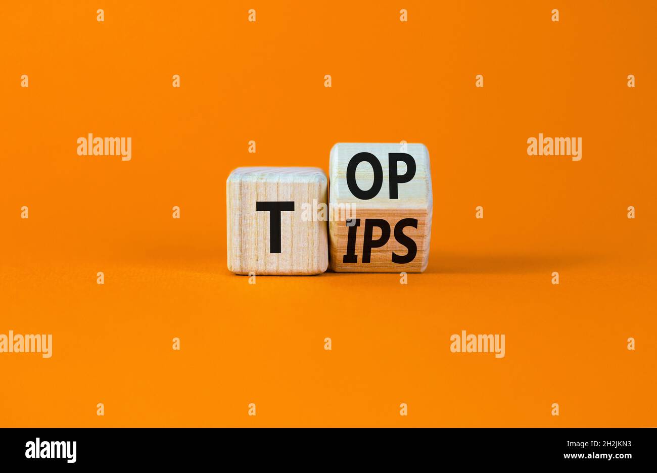 Top tips symbol. Turned a wooden cube with words 'Top tips'. Beautiful ...