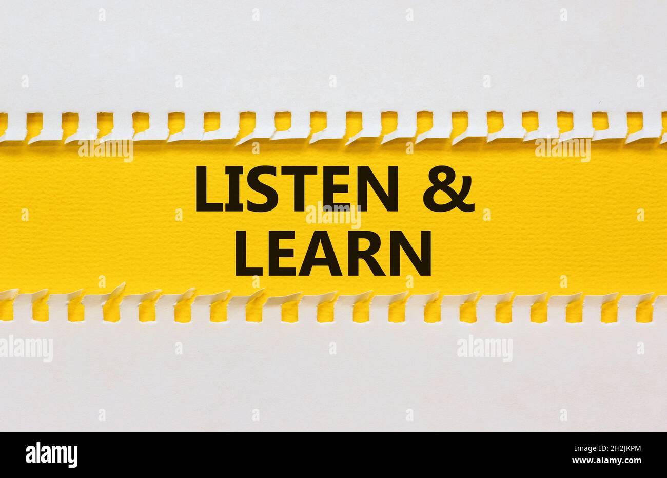 Listen and learn symbol. White and yellow paper with words 'Listen and ...