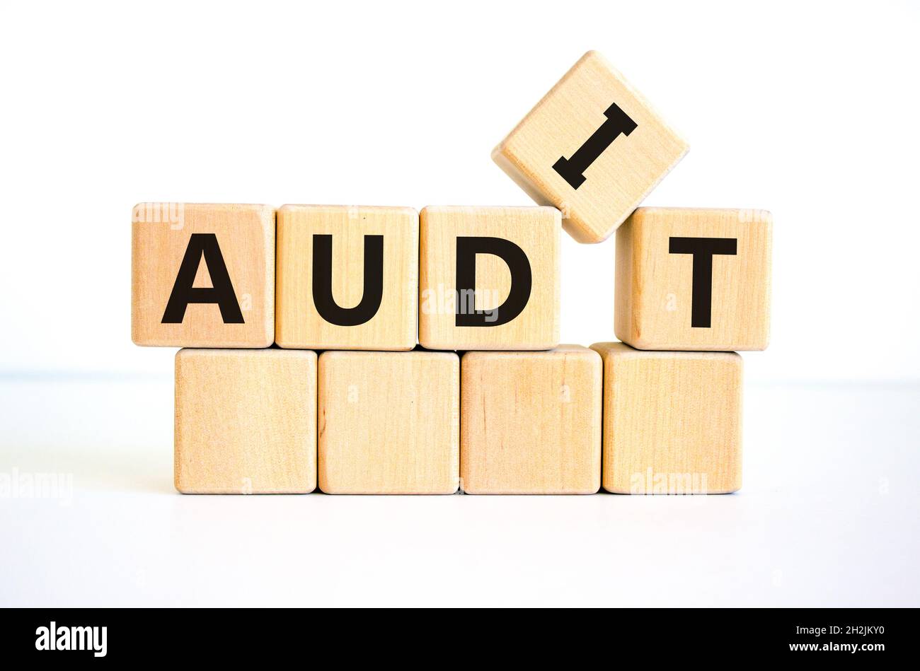 Audit symbol. The concept word 'audit' on wooden cubes. Beautiful white ...