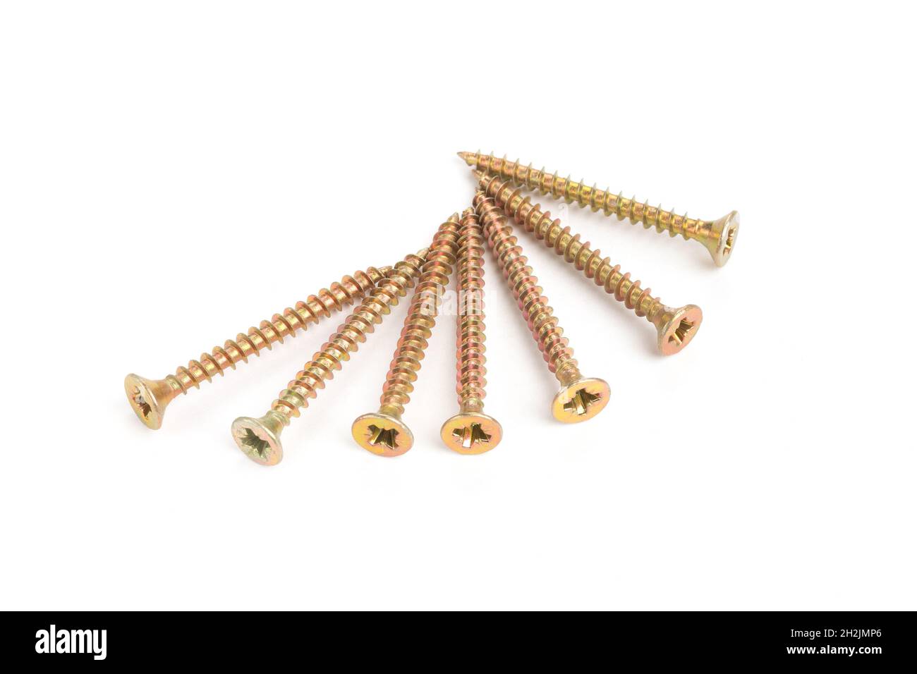 Yellow color screws lying part of a circle on a white background ...