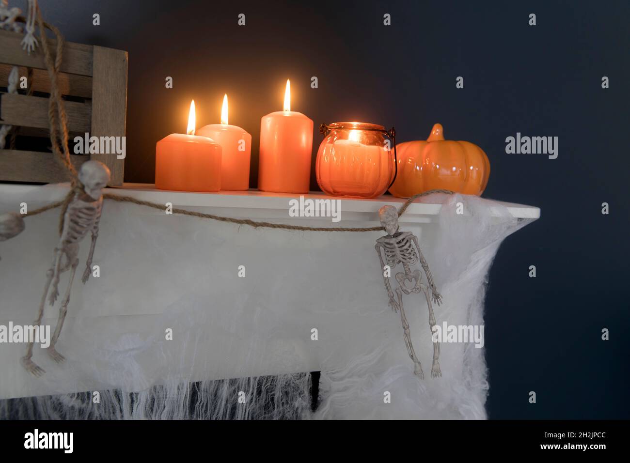 Halloween home decoration. Plastic toy skeletons in a wooden box on ...