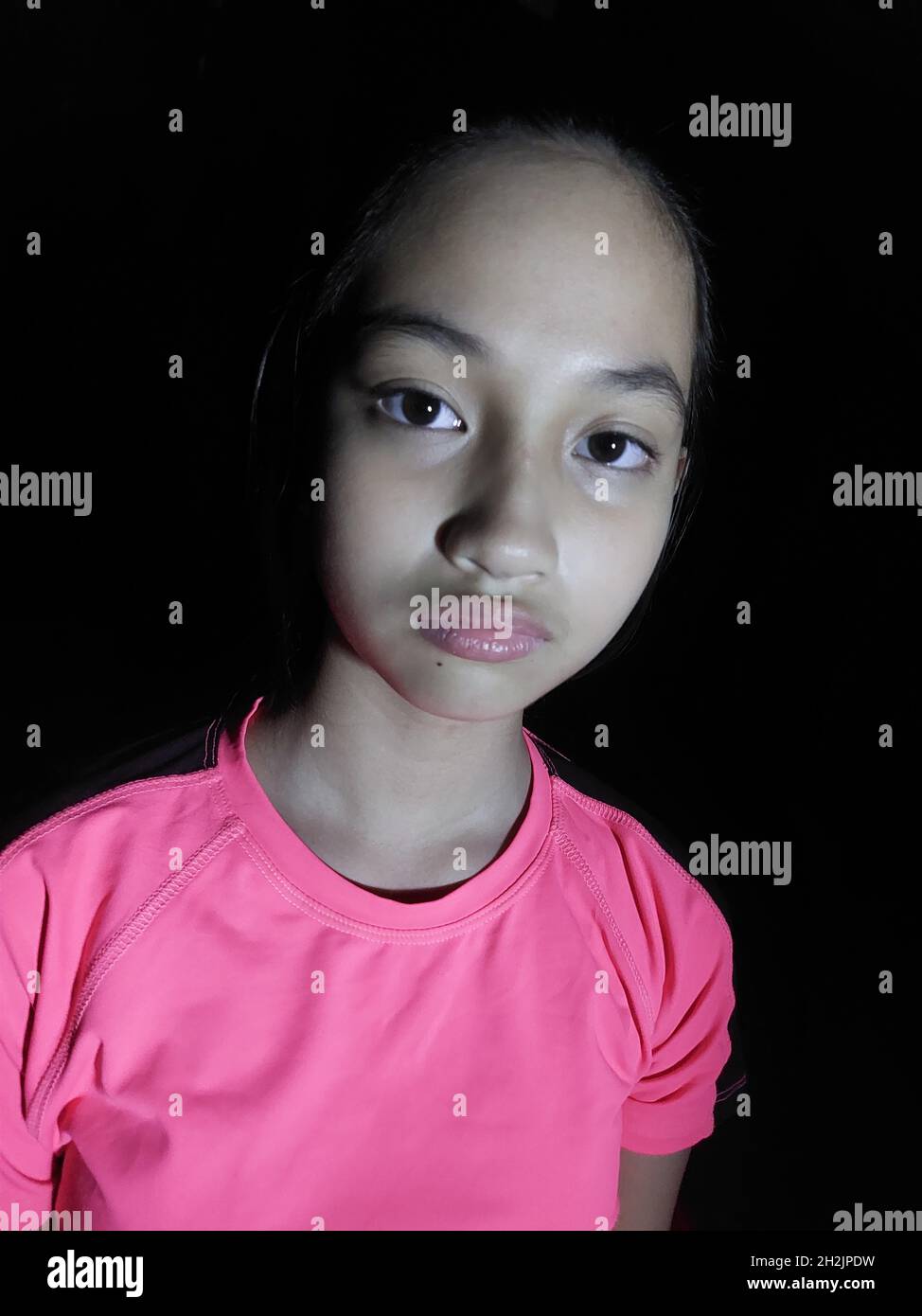 Serious Minority Female Tween Wearing Pink Isolated On Black Stock ...