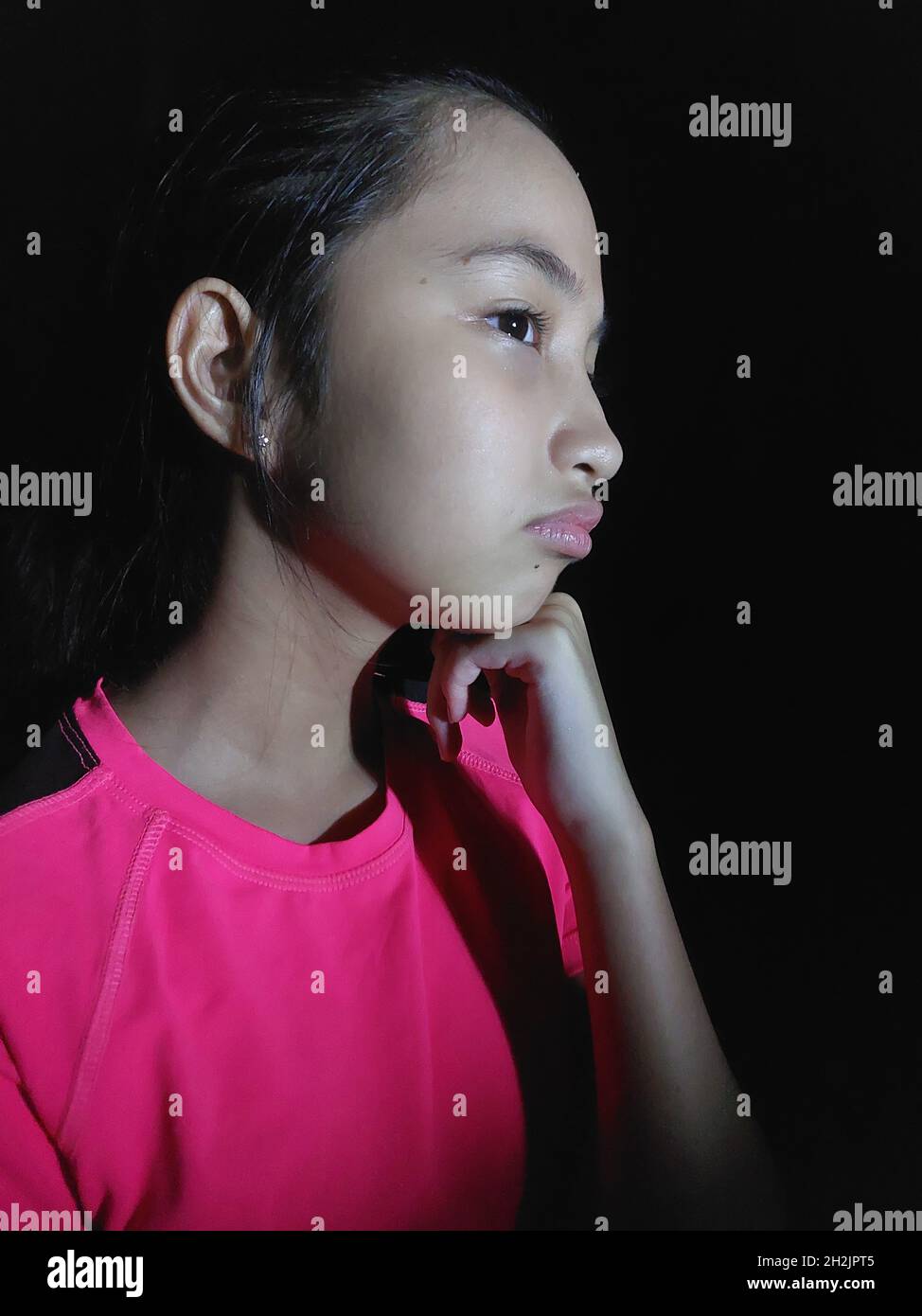 Young Asian Female Decision Making Wearing Pink Isolated On Black Stock ...