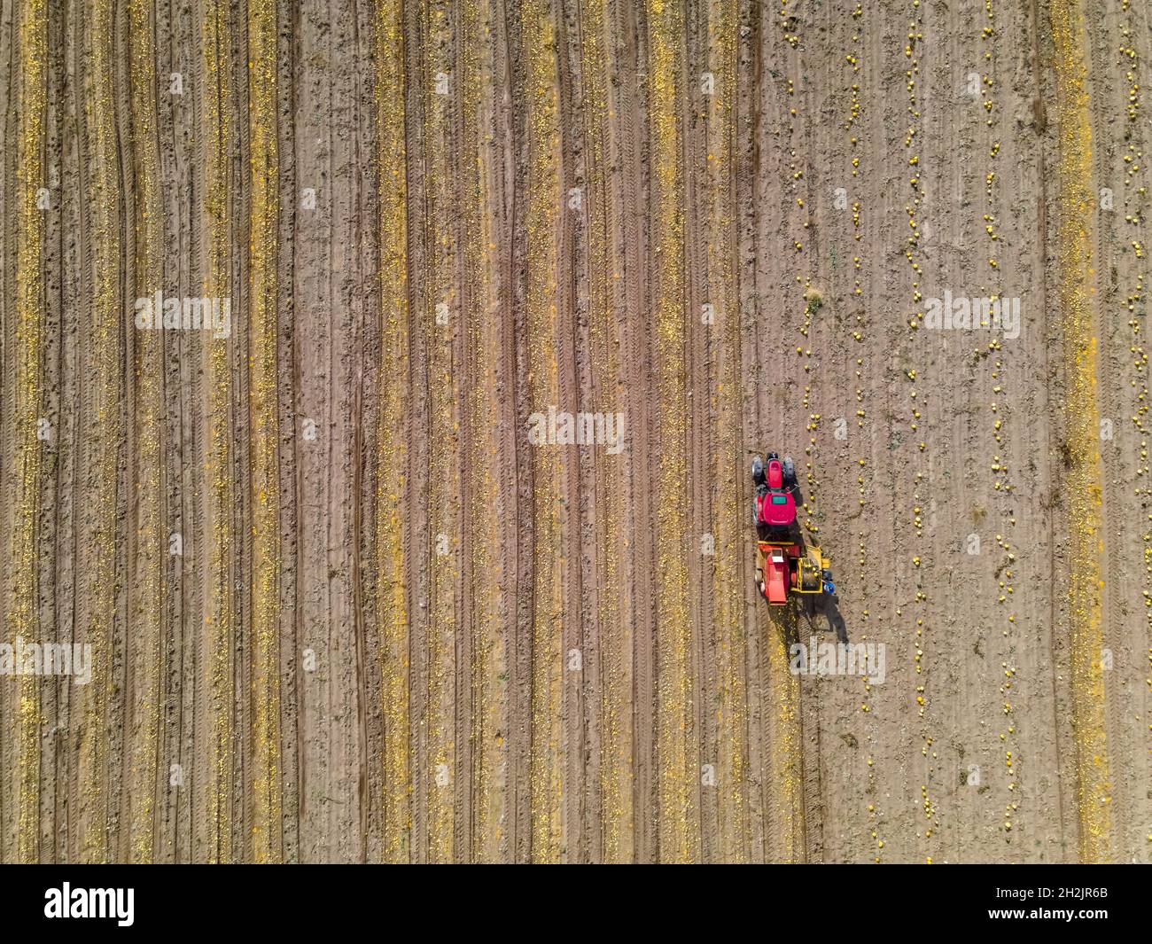 Aerial view of an industrial tractor working on land Stock Photo - Alamy